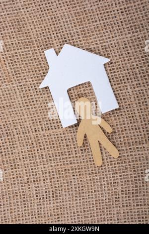 Paper man shape beside a house shape in view Stock Photo - Alamy