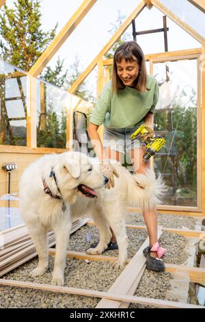 Female Carpenter Playing with Her Dog Stock Photo - Alamy