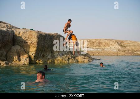 Mosul, Iraq. 22nd July, 2024. A fisherman sits on his boat on the Mosul ...