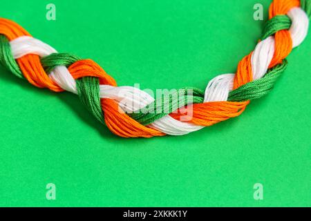Braided embroidery threads in colors of Indian flag on green background ...