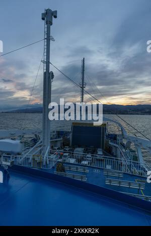 Car ferry crossing the street of Messina with view at the illuminated ...