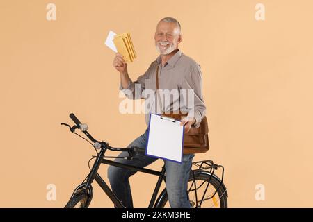 Happy postman with bicycle delivering letters on beige background Stock ...