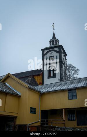 The Roros Church stands amidst of traditional Scandinavian wooden homes ...