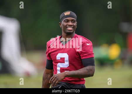 Washington Commanders cornerback Mike Sainristil, right, is pushed out ...