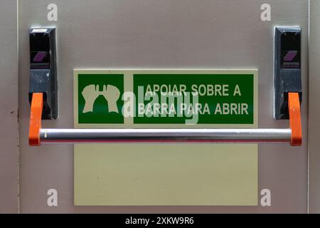 Emergency exit door panic bars with signage Stock Photo - Alamy