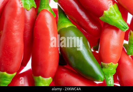 Set of small red chillies, one green isolated.Use for image background ...