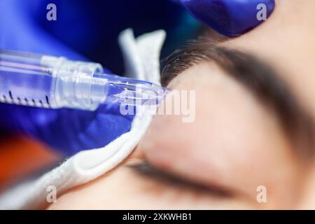 Female patient receiving a mesotherapy hydration procedure on eyelids ...
