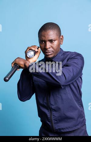 Trained bodyguard inspecting the perimeter with flashlight and weapon ...