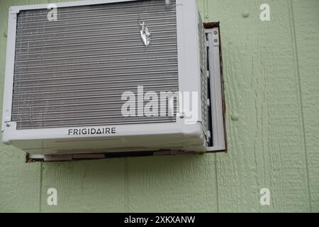 A window mounted AC unit fitted in a wall opening Stock Photo - Alamy