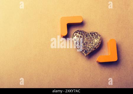 Gold color heart shaped decorative object in brackets in view Stock ...