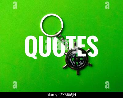 A top view of a compass keychain on a green background with copy space ...