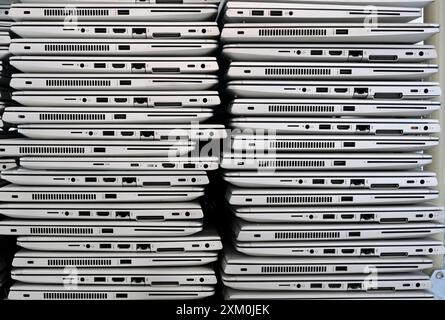 Big stacks of discarded laptops, notebooks on a trolley Stock Photo - Alamy