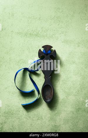 Carved wooden love spoon with blue ribbon Stock Photo - Alamy