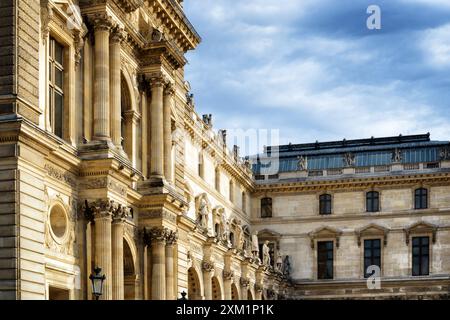 Columns and sculptures that adorn the facade of the Louvre in Pa Stock ...