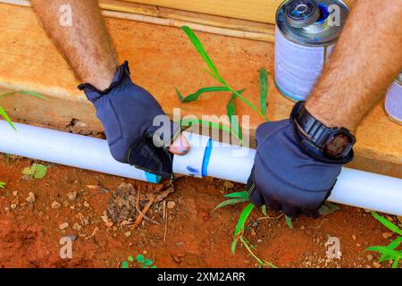 Contractor installing glues, plastic PVC pipes for laying water ...