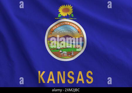 Kansas US state flag depicted on folded wavy fabric of old cloth close ...