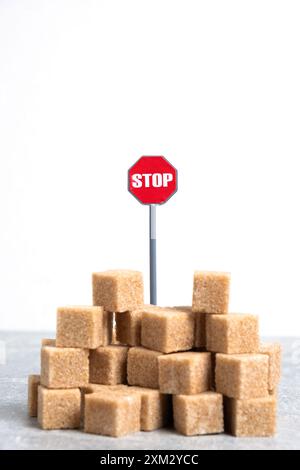 Sugar cubes and stop sign on yellow background. Conceptual image Stock ...