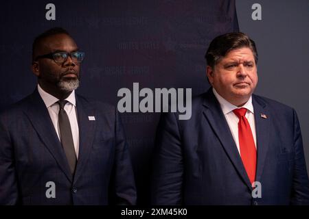 Illinois Gov. J.B. Pritzker, right, speaks with Leonel Tovar at his ...