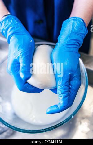 A small family cheese factory in the Carpathian village. Molding press ...