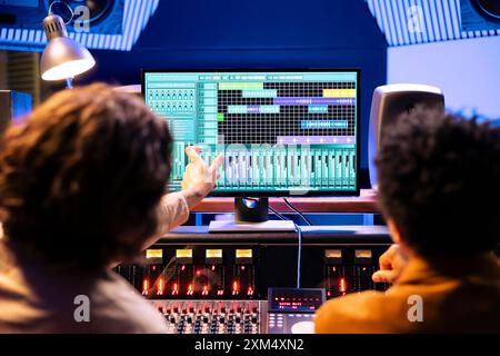Singer and expert mixing and processing music for a new album in ...