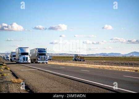 Heavy duty carriers long haulers white big rig semi trucks transporting ...