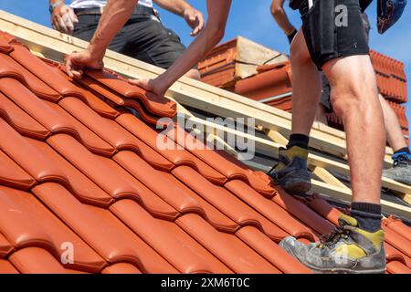 Roofing work, new covering of a tiled roof Stock Photo - Alamy