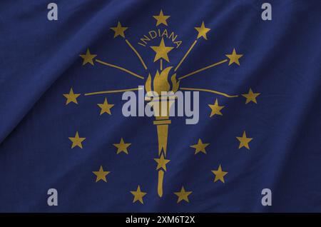 Indiana US state flag depicted on folded wavy fabric of old cloth close ...