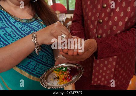 Indian Couple Making Offerings At Altar Stock Photo - Alamy