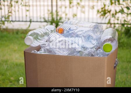 plastic bottles in brown recycle garbage box Stock Photo - Alamy