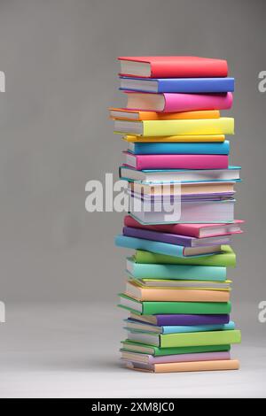 Stack of colorful books on light grey background, space for text Stock ...