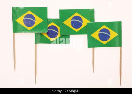 Small paper flags of Brazil isolated on white Stock Photo - Alamy