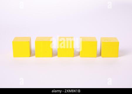 Many yellow wooden cubes isolated on white Stock Photo - Alamy