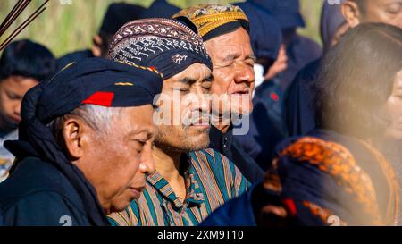 Javanese people pray during the Larungan ceremony on Mount Kelud Stock ...