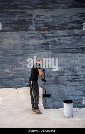 Construction site, application of a bitumen coating to a concrete ceiling, preparation for ...