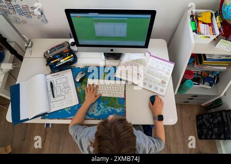 Young, primary school pupils, home learning, doing schoolwork, distance ...