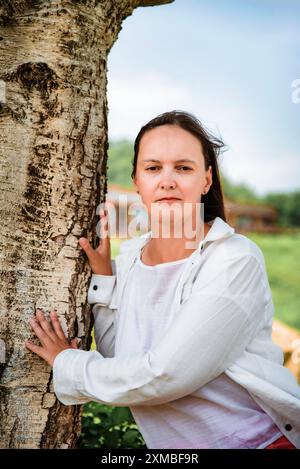 portrait of a young woman without make up and with long hair on a white ...