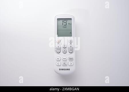 A white SAMSUNG Air Conditioner (AC) remote controller with LCD screen ...