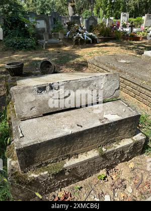 Damaged broken tombstone in the public cemetery Stock Photo - Alamy