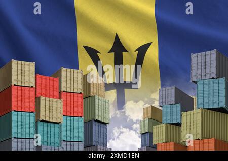 Barbados flag and big stack of shipping cargo containers in docks with ...