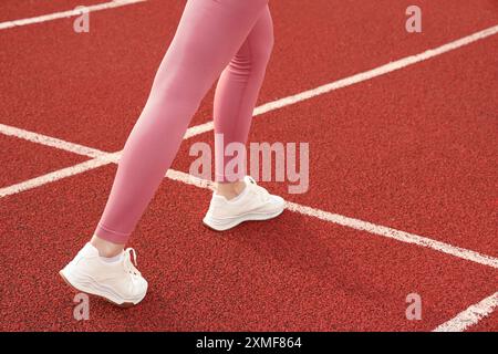 Woman going along starting line at stadium. Concept of new beginning ...