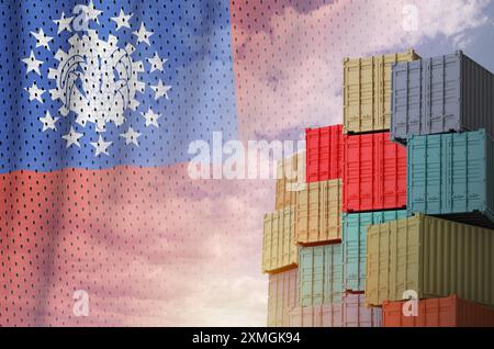 Myanmar flag and big stack of shipping cargo containers in docks with ...