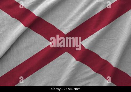 Alabama US state flag depicted on folded wavy fabric of old cloth close ...