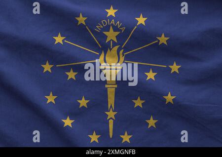 Indiana US state flag depicted on folded wavy fabric of old cloth close ...