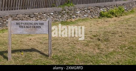Rustic No Parking on Village Green sign Stock Photo - Alamy