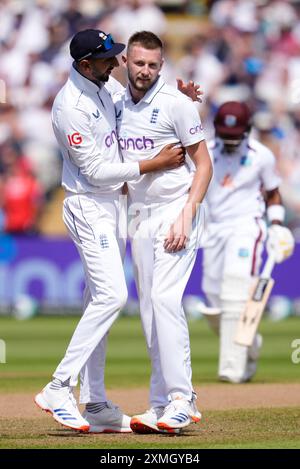 England's Gus Atkinson (right) celebrates tacking the wicket of ...