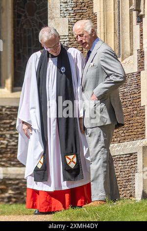 King Charles III speaks with The Reverend Mark Birch during an Advent ...