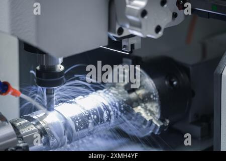 A modern cnc machine produces a piece of metal part using the milling ...