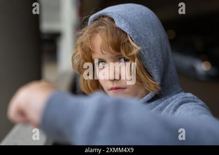Kid boy in hoodie fighting. Little kid boy fighting outside. Angry ...