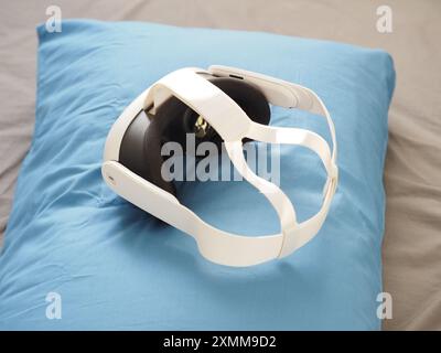 VR headset on pillow. Interacting with Augmented Reality lying on bed ...