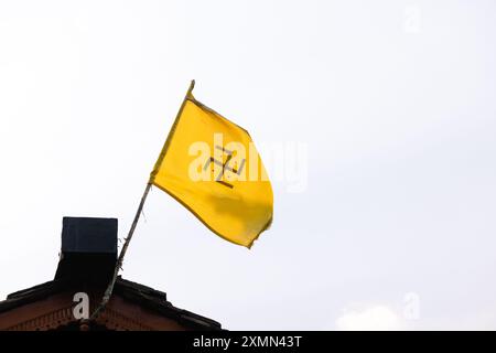 Yellow flag on roof of Indian Temple swastika is used as a symbol ...
